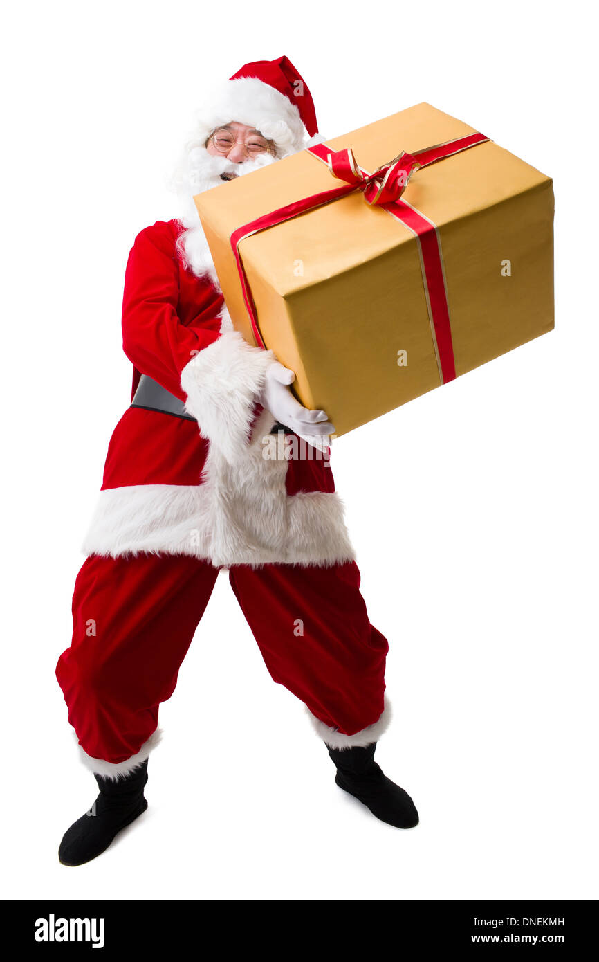 Santa Claus with heavy Christmas gift Stock Photo - Alamy