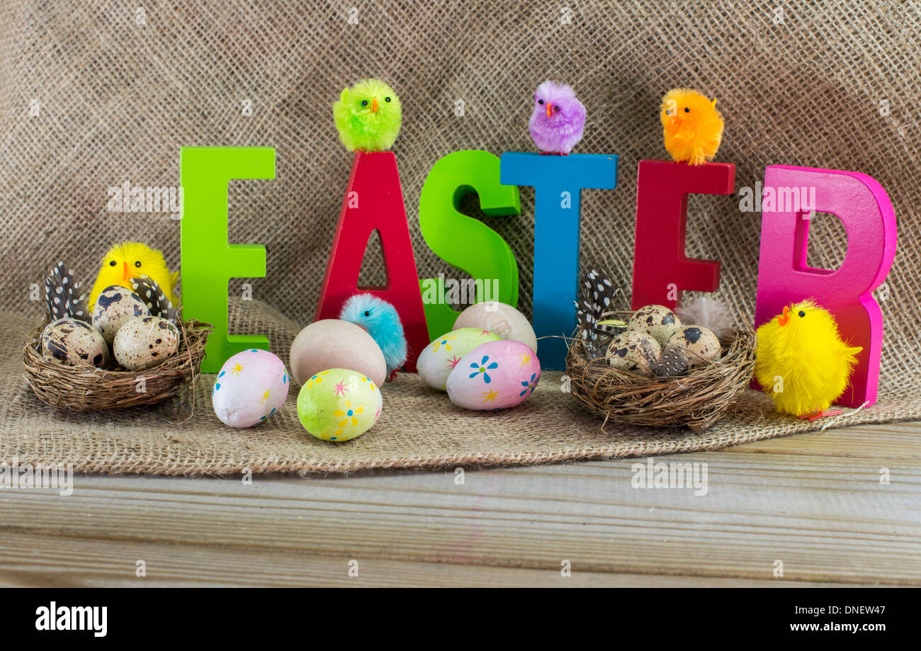 easter with letters on wooden table and jute background Stock Photo - Alamy