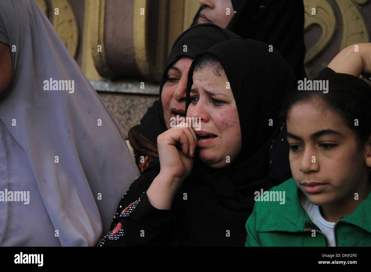 Mansura, Cairo, Egypt. 24th Dec, 2013. Egyptian mourners participate in ...