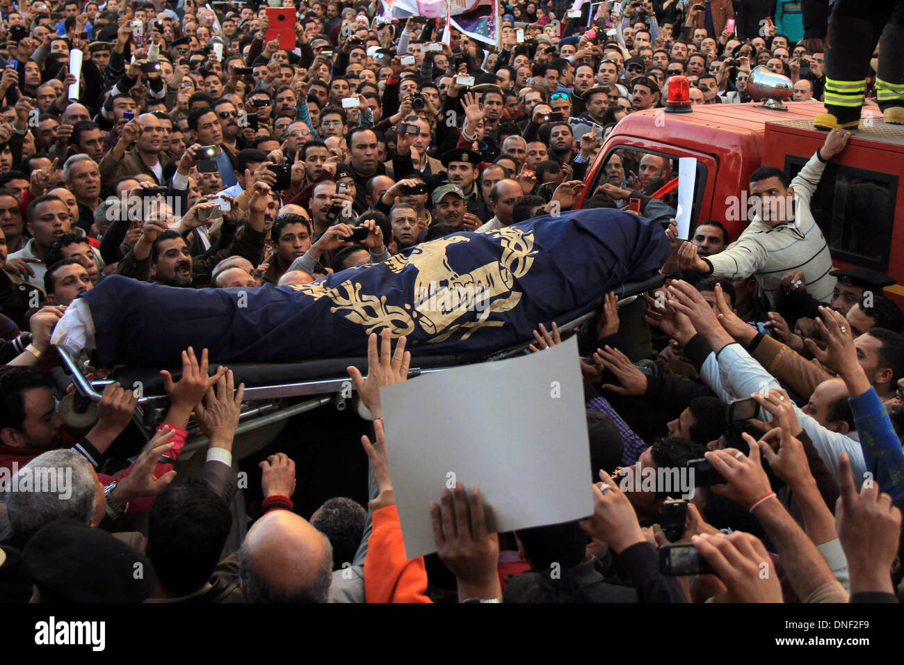 Mansura, Cairo, Egypt. 24th Dec, 2013. Egyptian mourners participate in ...