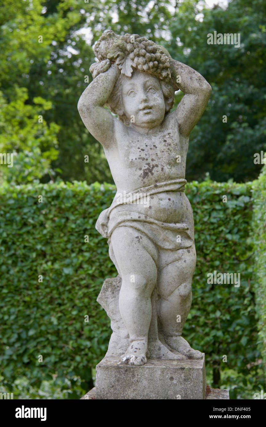 Statuette of a figure holding a bunch of grapes above his head, Castle ...