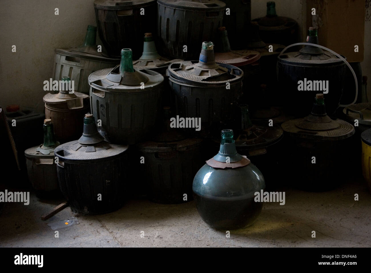 Old demijohns sit in a storage room in a house of El Gastor village in ...