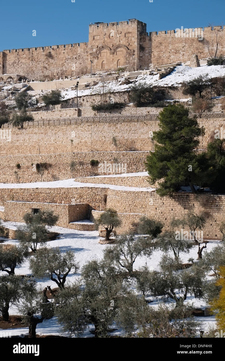 Snow blankets Kidron Valley and the sealed arched Golden Gate or Bab al ...