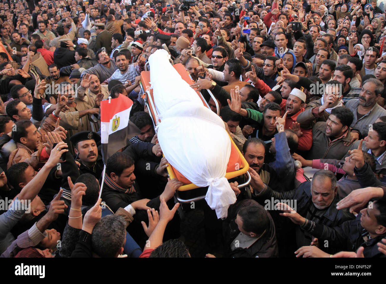 Mansura, Cairo, Egypt. 24th Dec, 2013. Egyptian mourners participate in ...