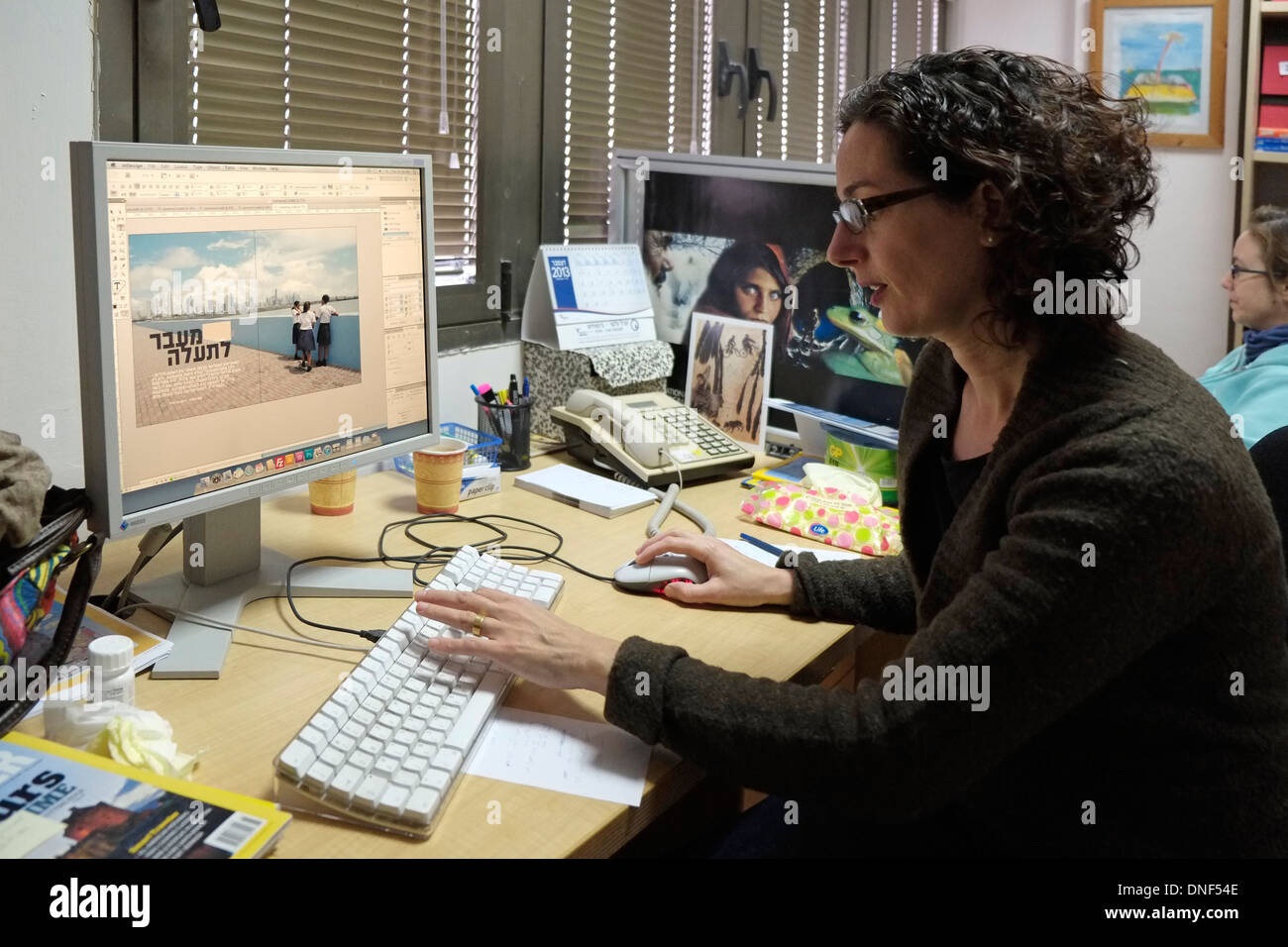 Graphic designer working at the editorial office of the Israeli edition ...