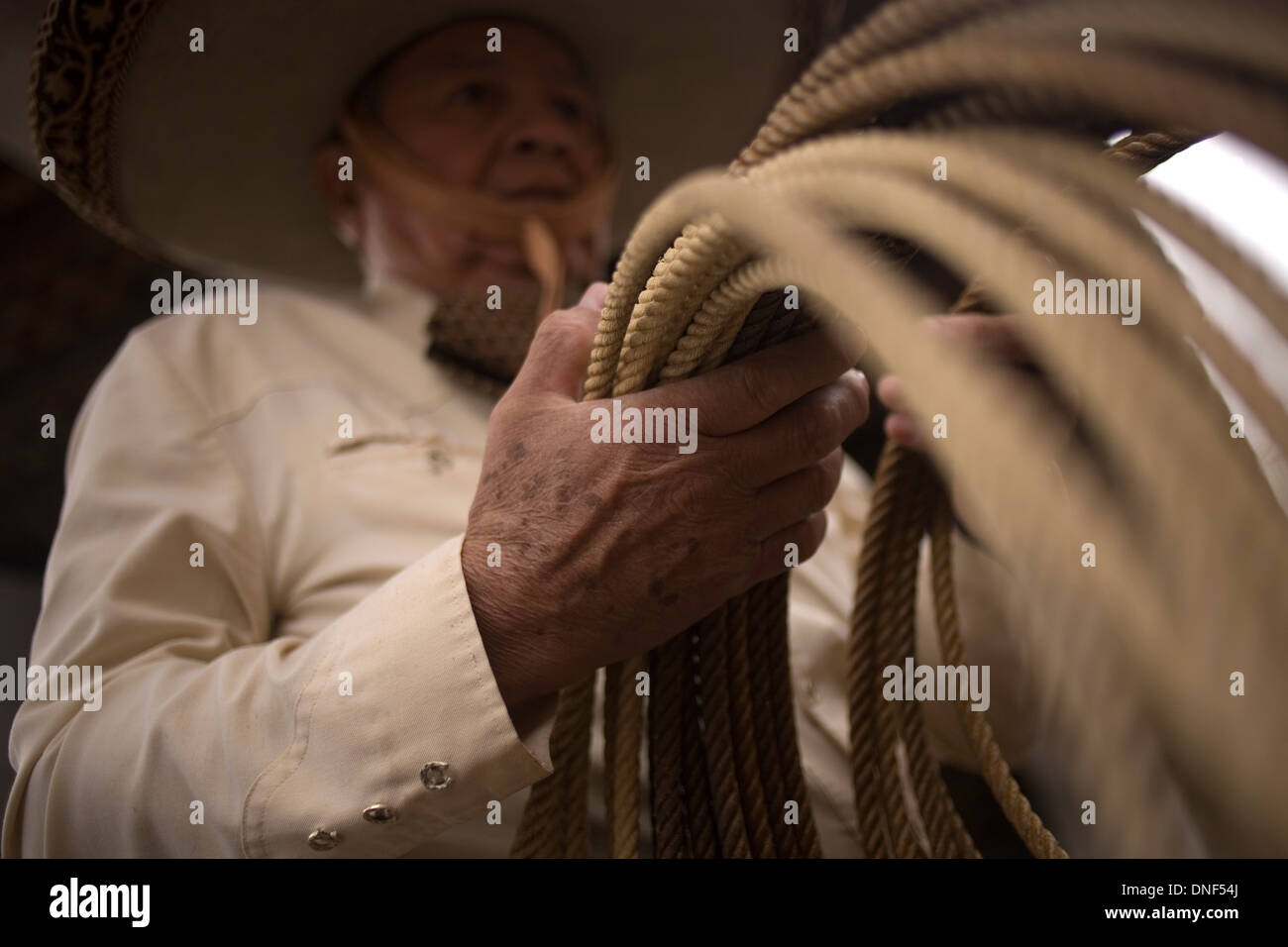 A charro holds a lariat during a Charreria rodeo event in Mexico City ...