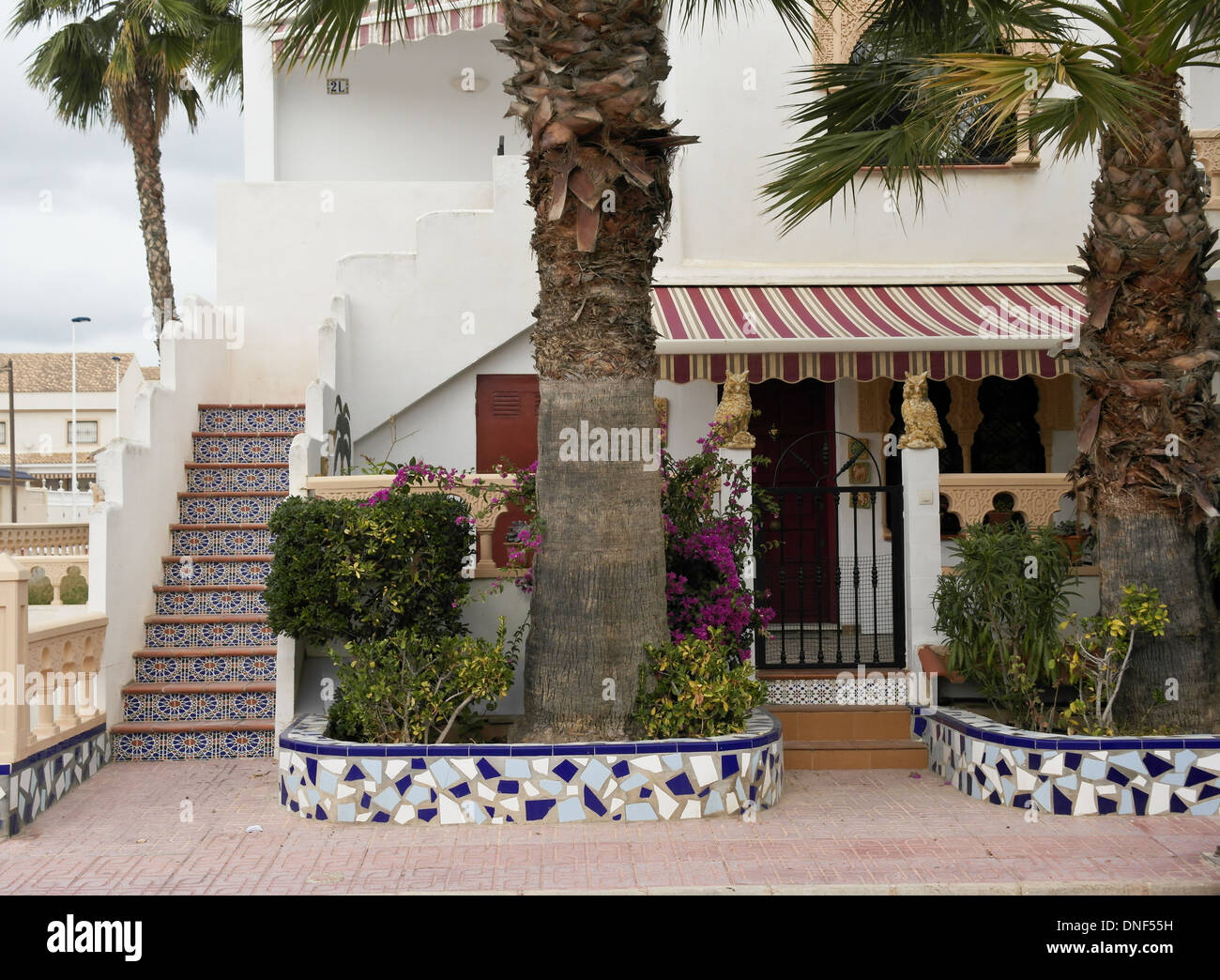 Spanish apartment with palm trees and mosaic wall Stock Photo - Alamy