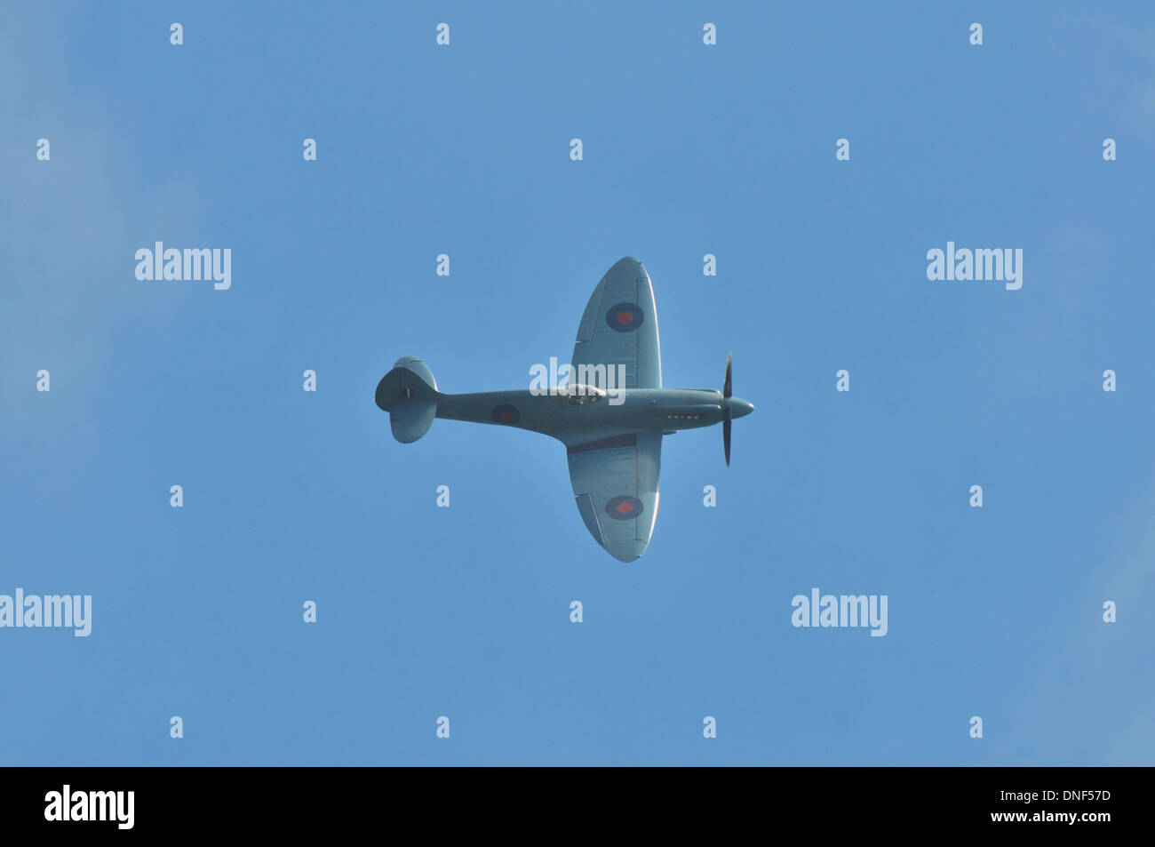Spitfire in WWII blue photo reconnaissance camouflage against blue sky ...