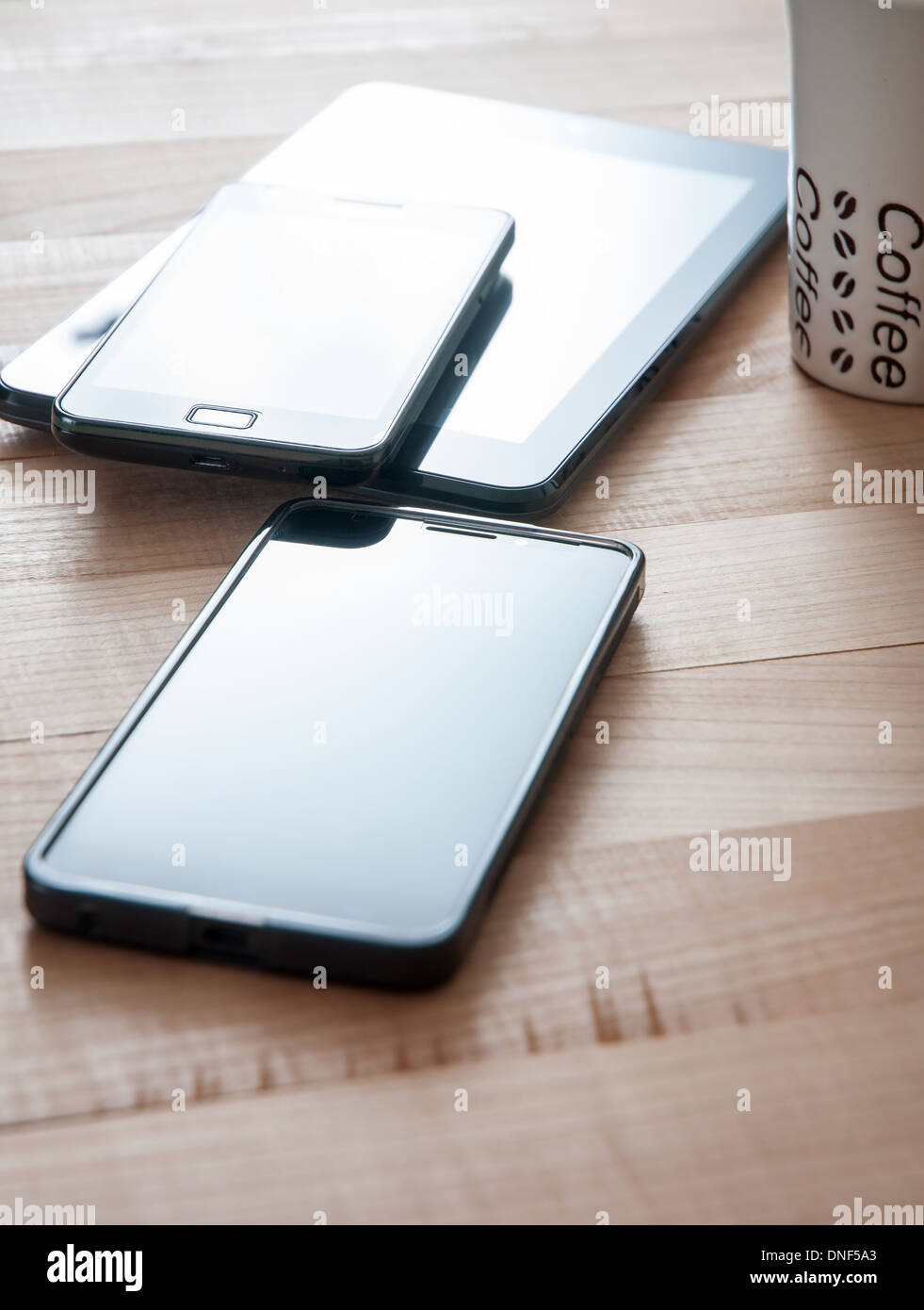 electronic devices and coffee on wooden table Stock Photo - Alamy