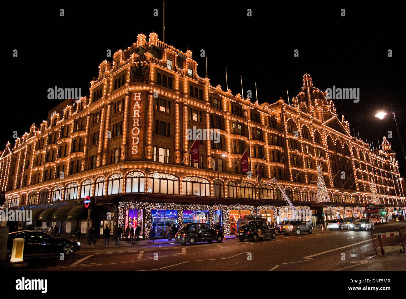 London, UK. 24th December 2013. A workman puts up flags on the side of ...