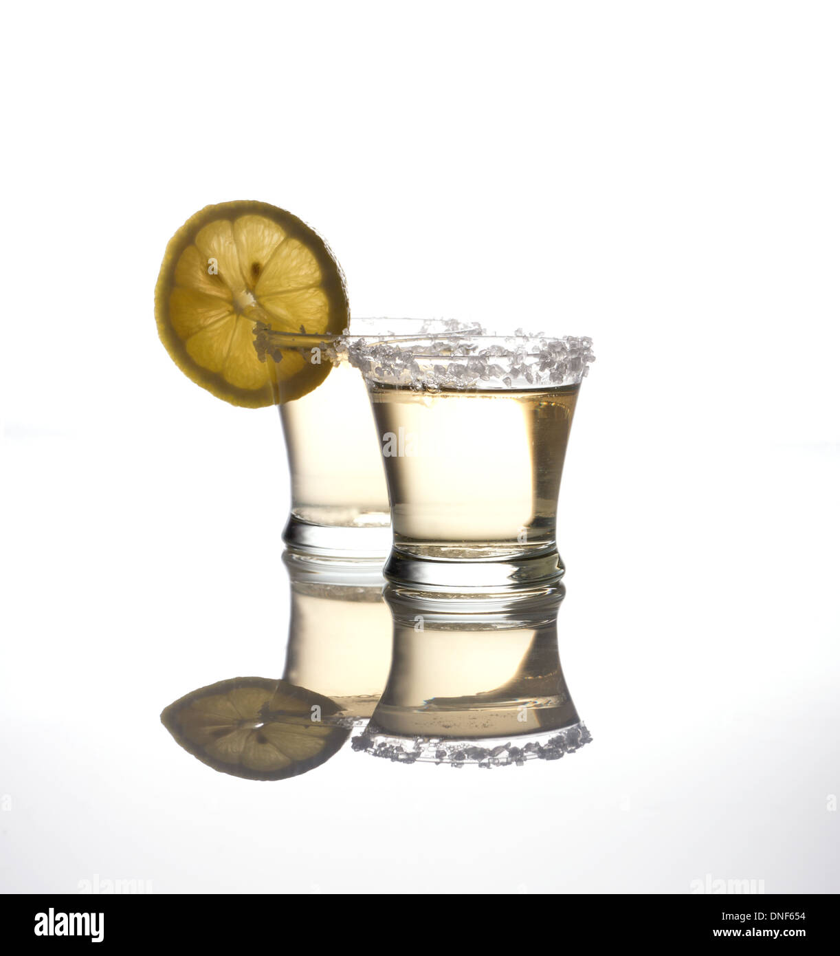 Two shots of tequila on white background with reflections Stock Photo ...