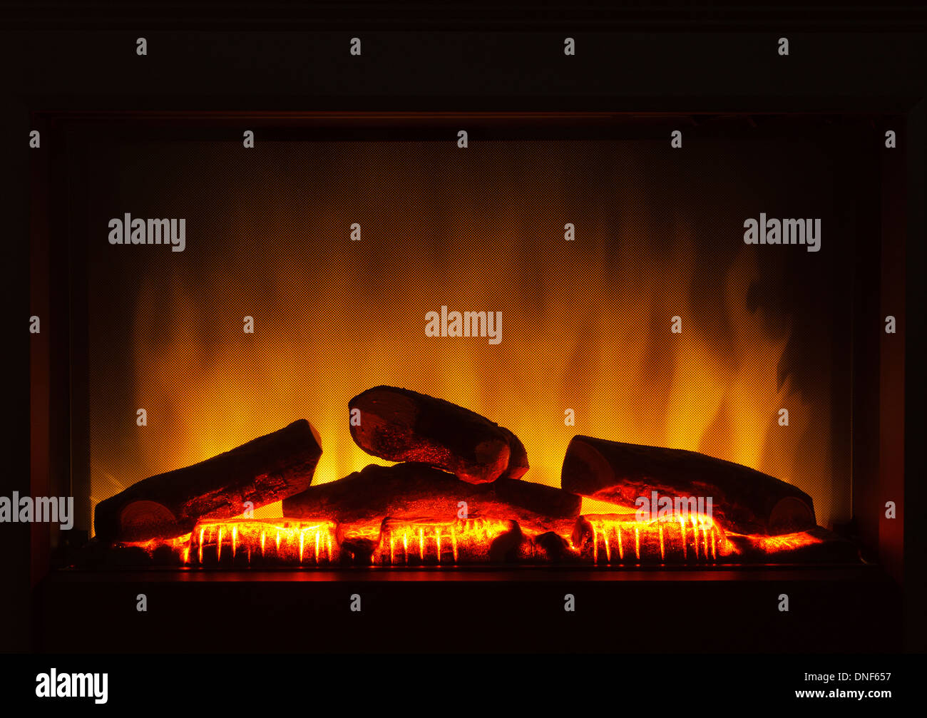 Closeup of electric artificial fireplace with orange fire flame ...