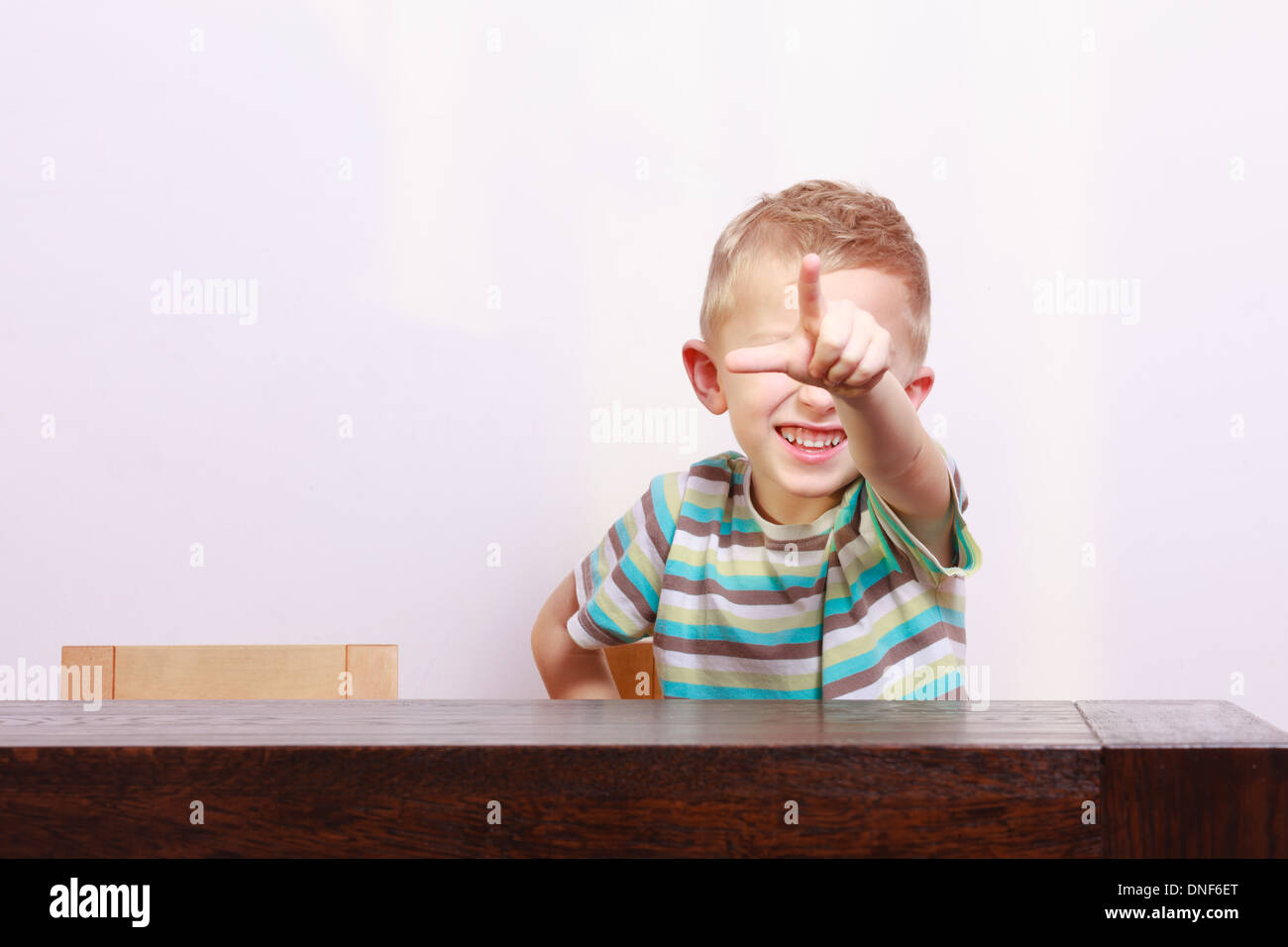 Portrait of happy blond cute boy child kid showing pointing at you at ...