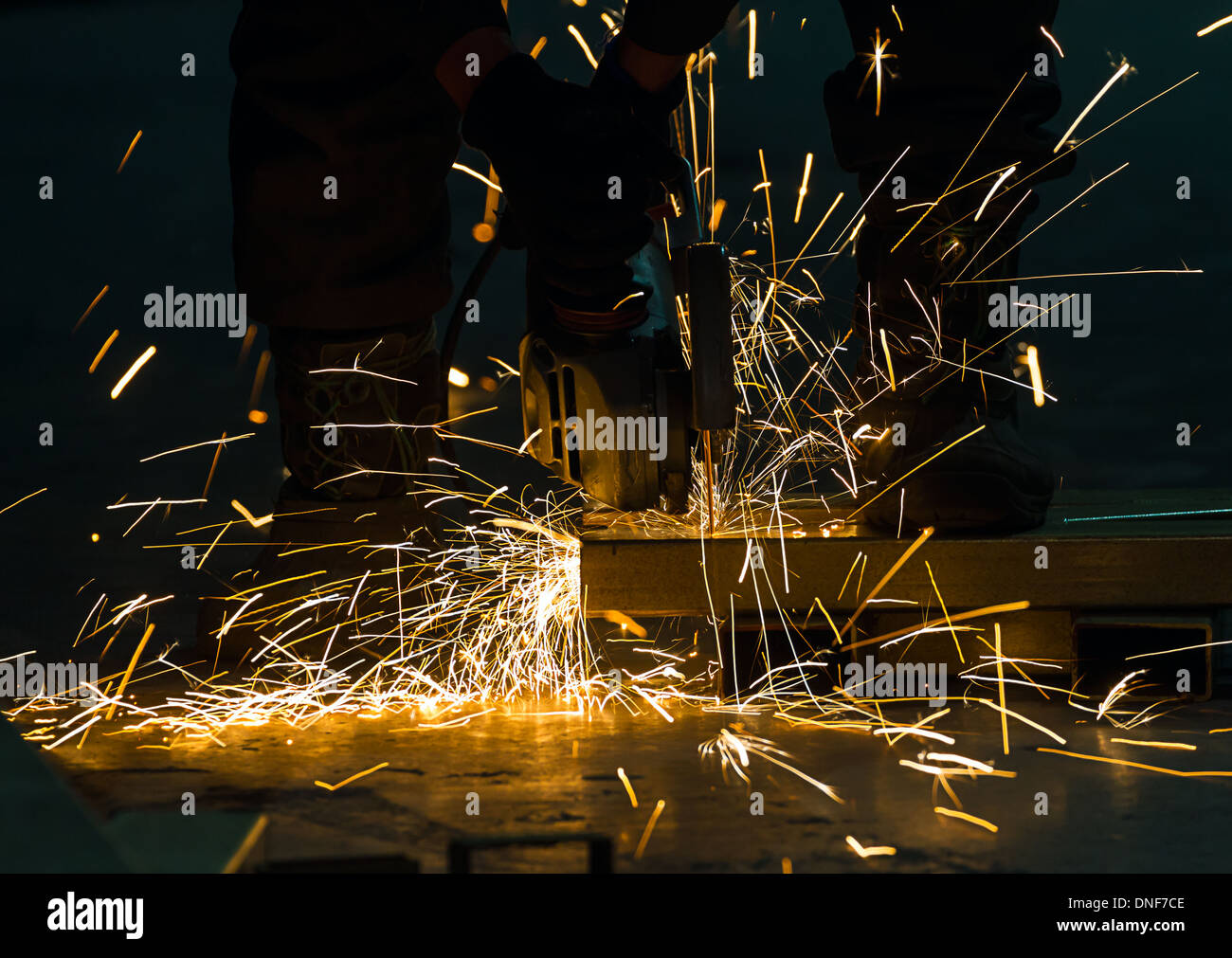 sharpening and cutting of iron by abrasive disk machine Stock Photo - Alamy