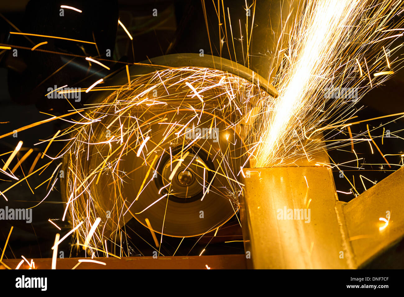 sharpening and cutting of iron by abrasive disk machine Stock Photo - Alamy
