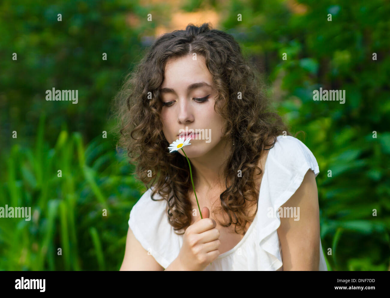 Beautiful romantic woman with daisy flower outdoors Stock Photo - Alamy