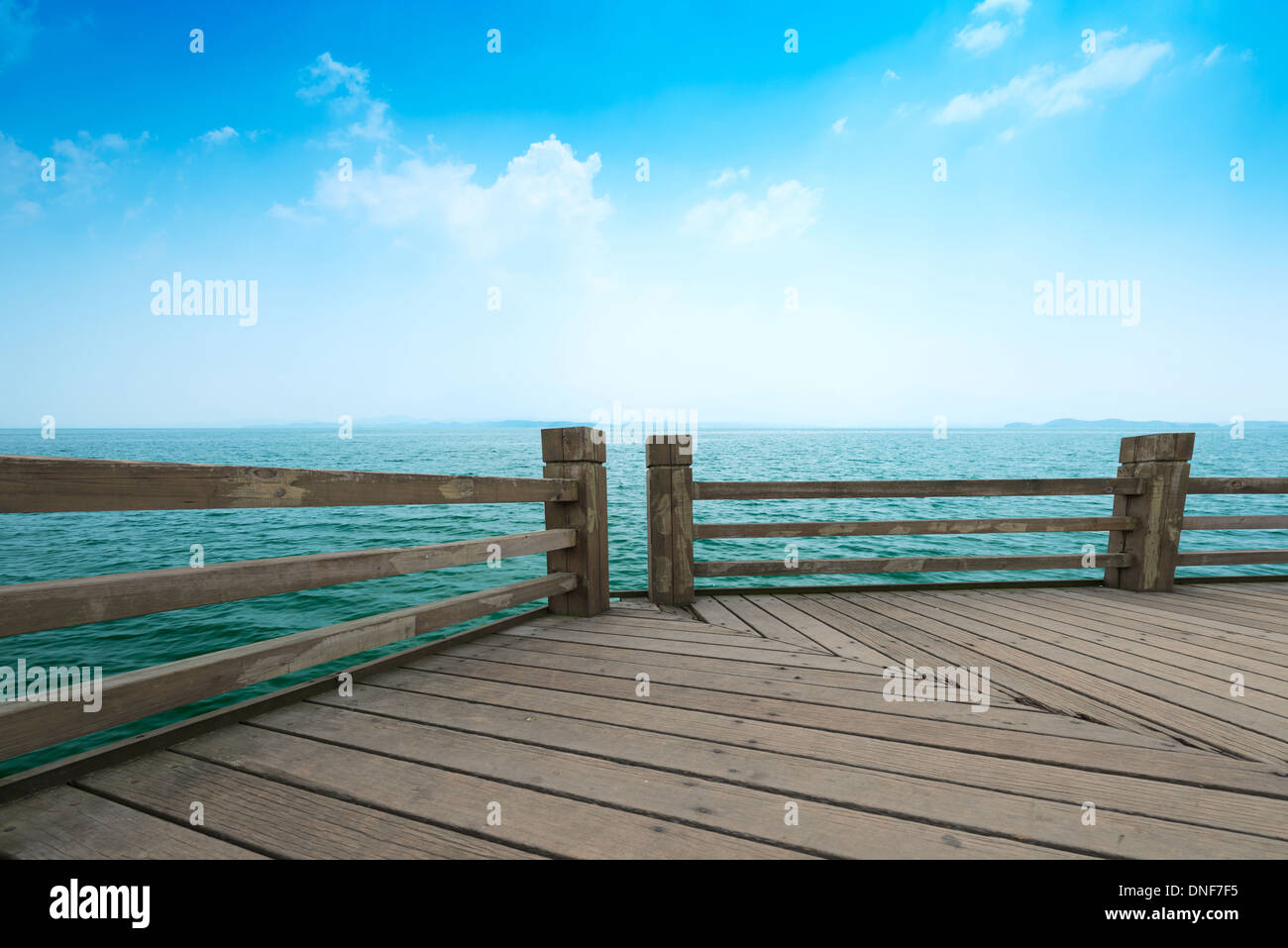 Wooden jetty over the beautiful Maldivian sea with blue sky Stock Photo ...
