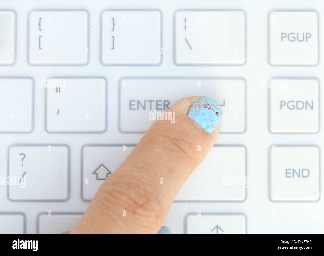 close-up finger pushing the enter button of keyboard Stock Photo - Alamy