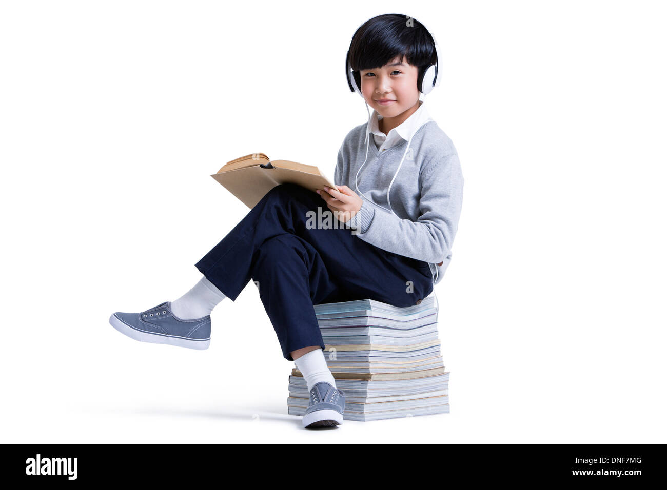 Child headphones child reading book Cut Out Stock Images & Pictures - Alamy