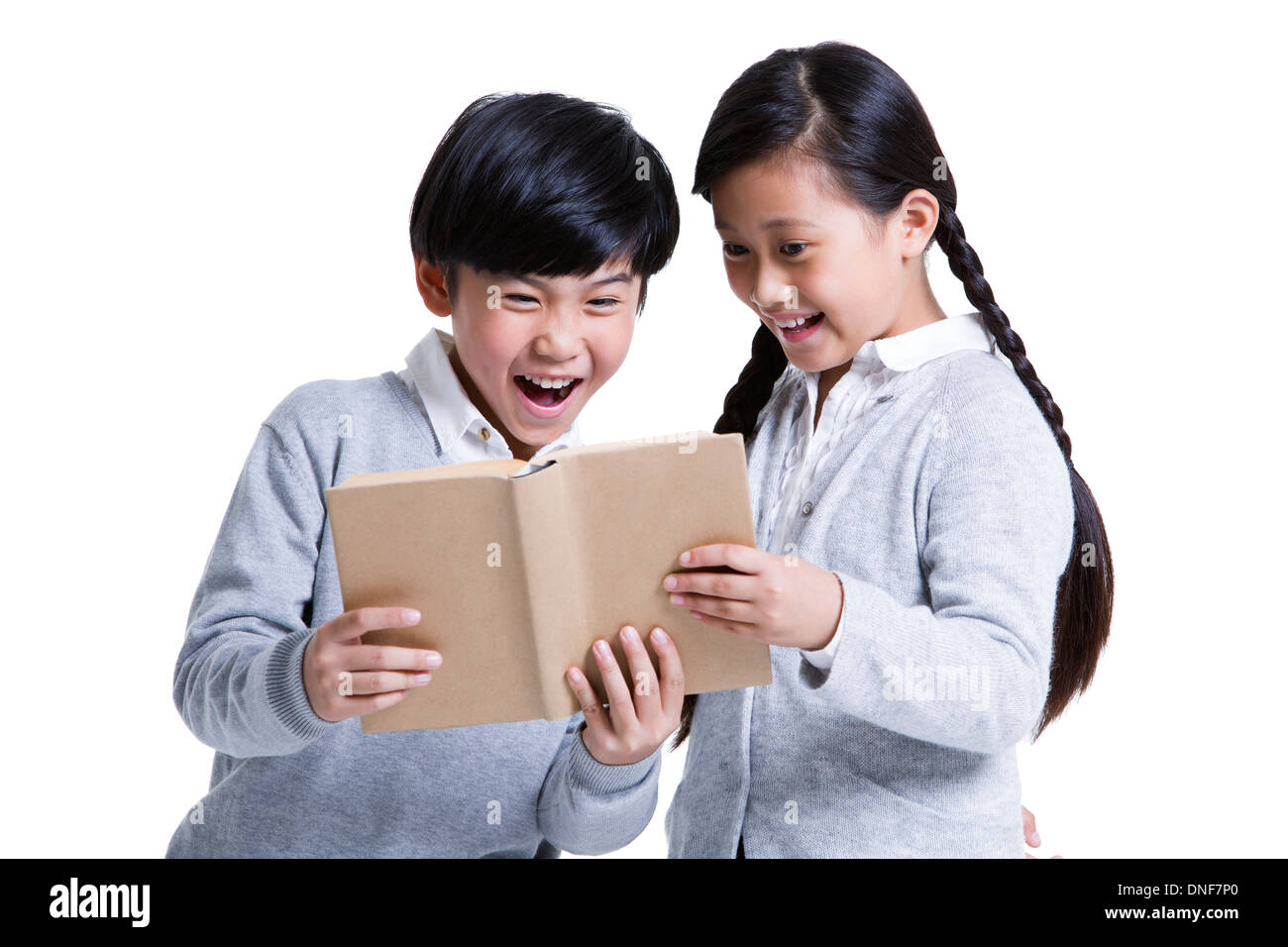 Cute boy and girl reading Stock Photo - Alamy