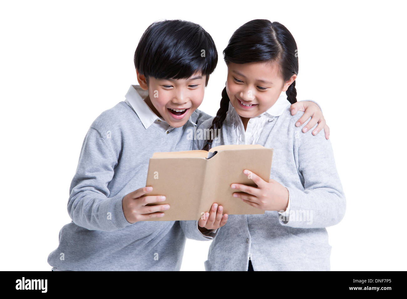 Cute boy and girl reading Stock Photo - Alamy