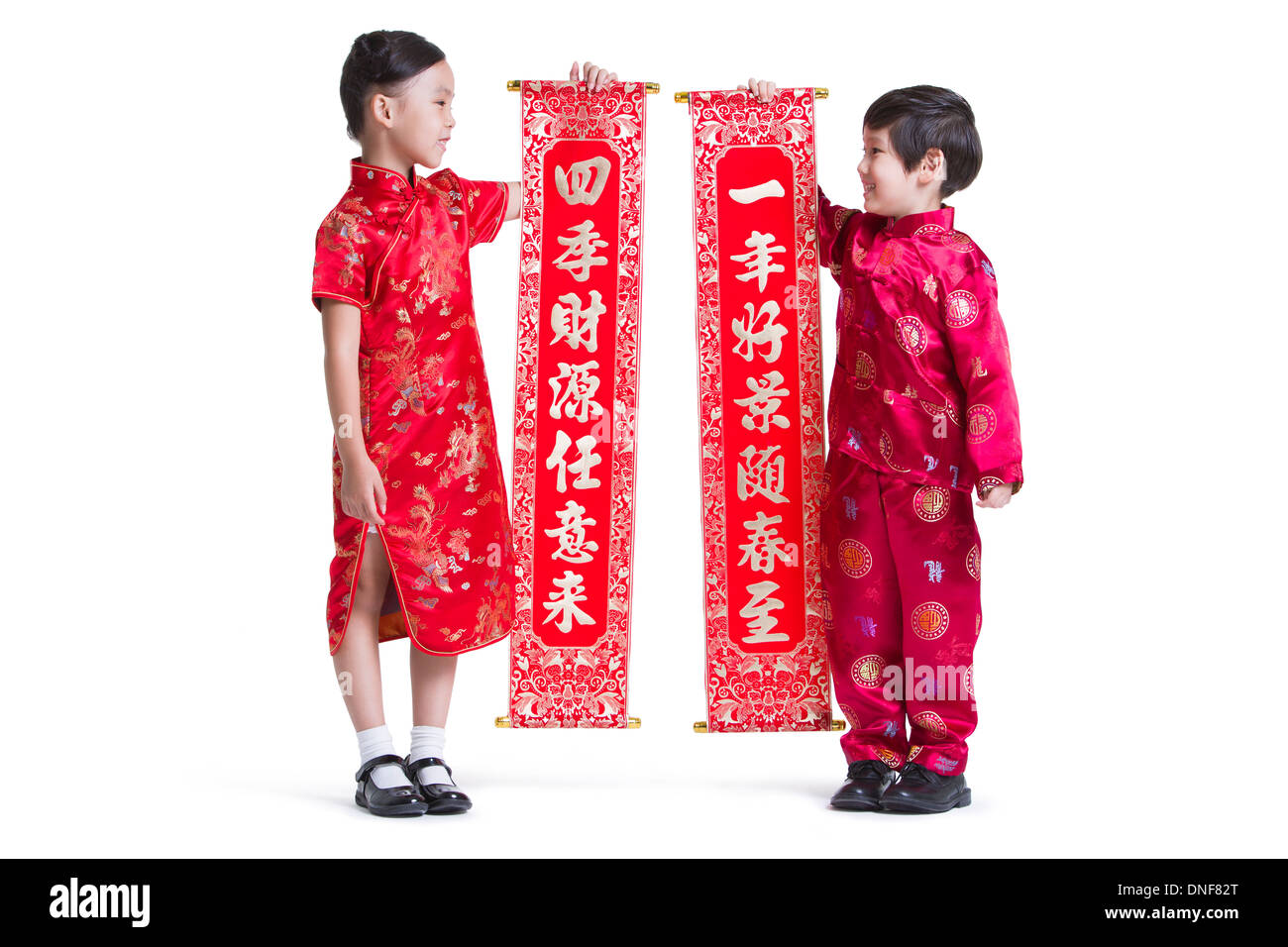 Cute children with couplets celebrating Chinese New Year Stock Photo ...
