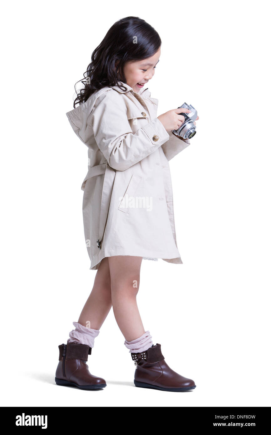 Cute little girl on the move with camera in hands Stock Photo - Alamy