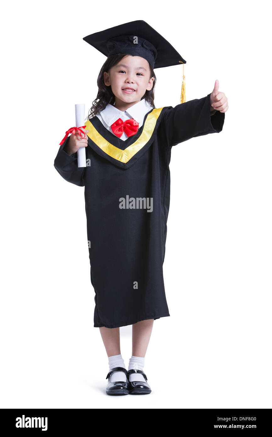Cute girl in graduation gown doing thumbs up Stock Photo - Alamy