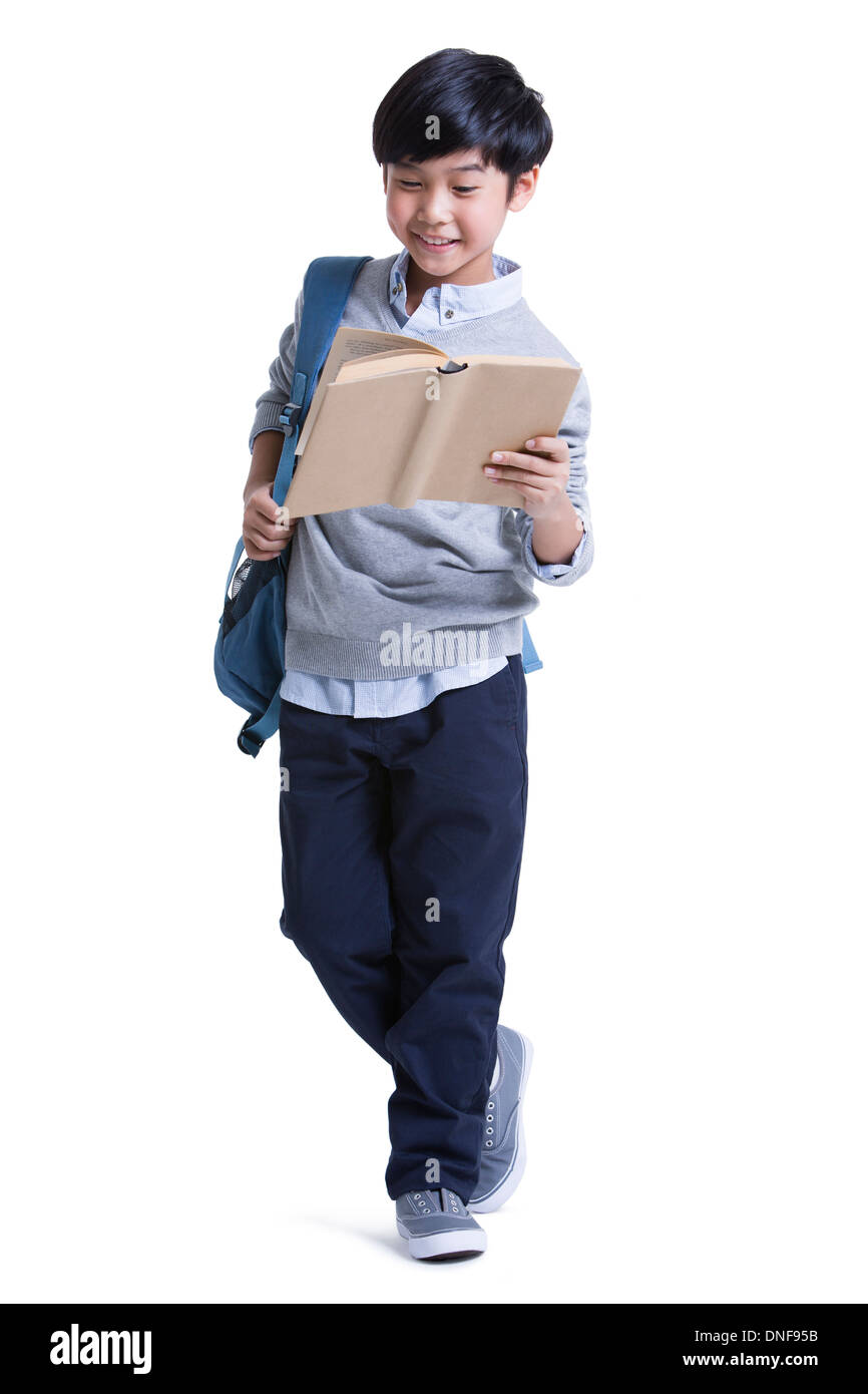 Cute schoolboy reading Stock Photo - Alamy