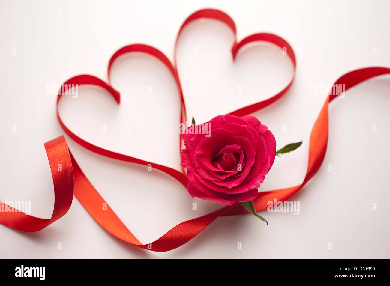 Red rose and red ribbons in heart shape Stock Photo - Alamy
