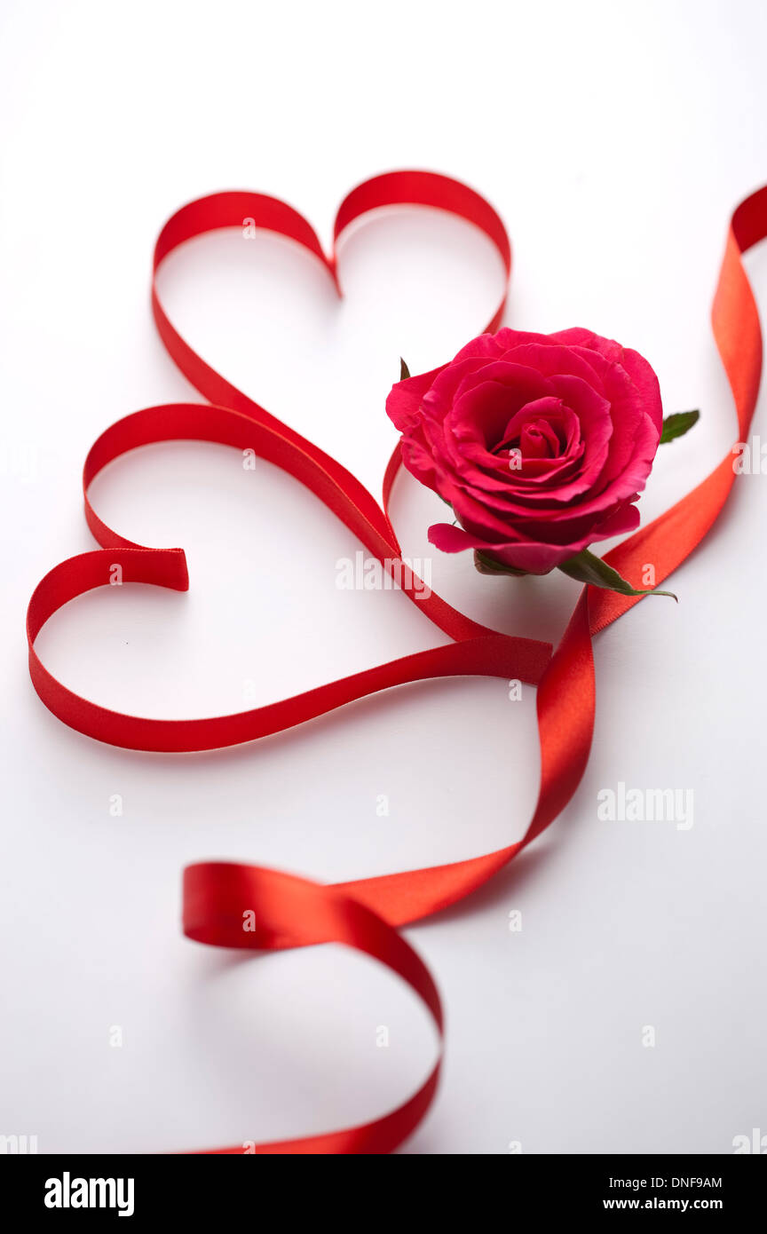 Red rose and heart shaped red ribbons Stock Photo - Alamy
