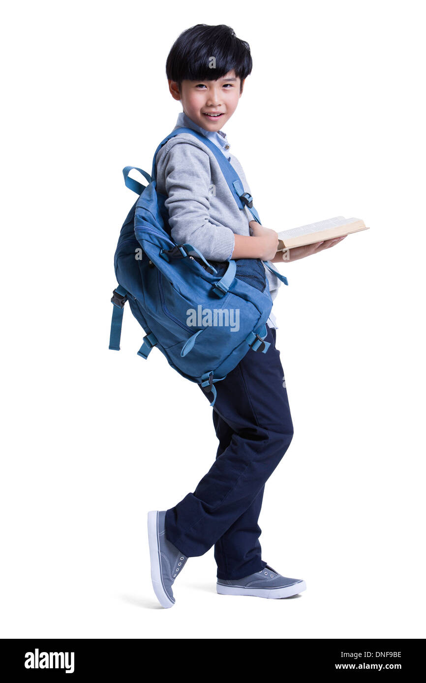 Cute schoolboy reading Stock Photo - Alamy