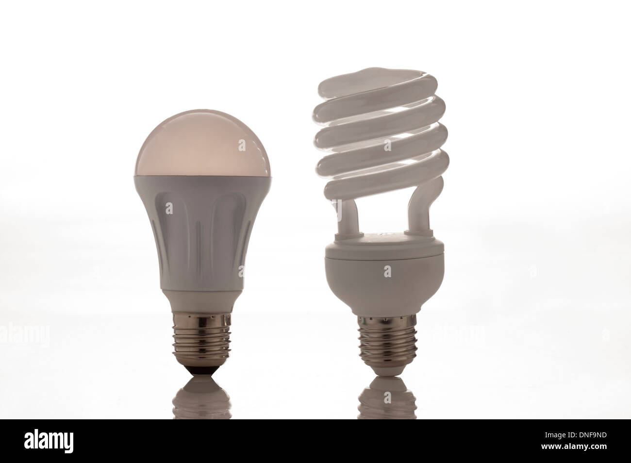 Normal light bulb versus energy saving light bulb Stock Photo - Alamy