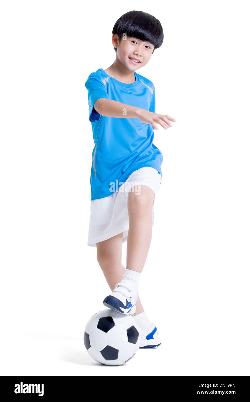 Healthy boy kicking football image hi-res stock photography and images ...