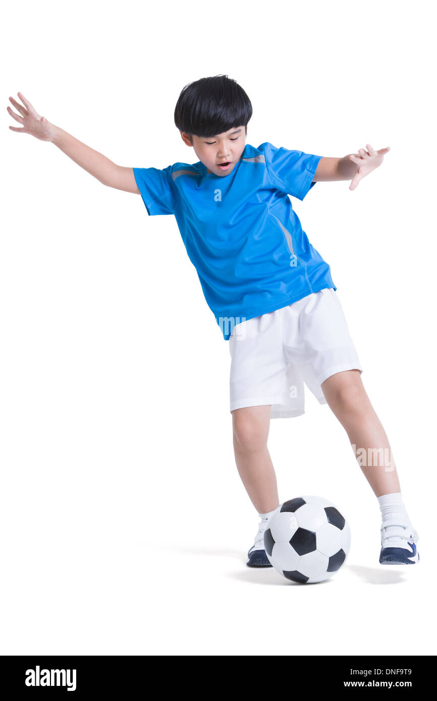 Cheerful boy playing football Stock Photo - Alamy