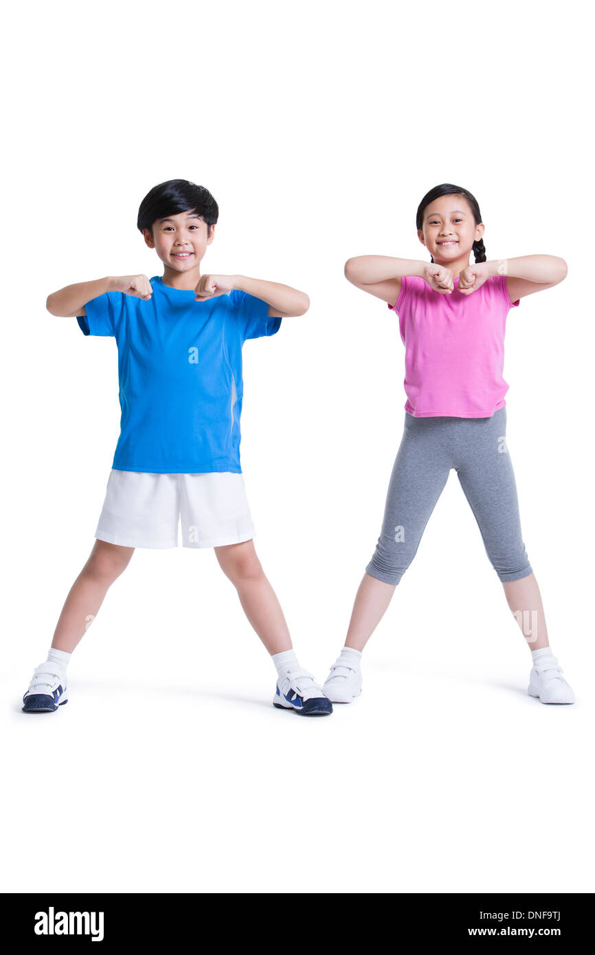 Happy boy and girl doing exercises Stock Photo - Alamy
