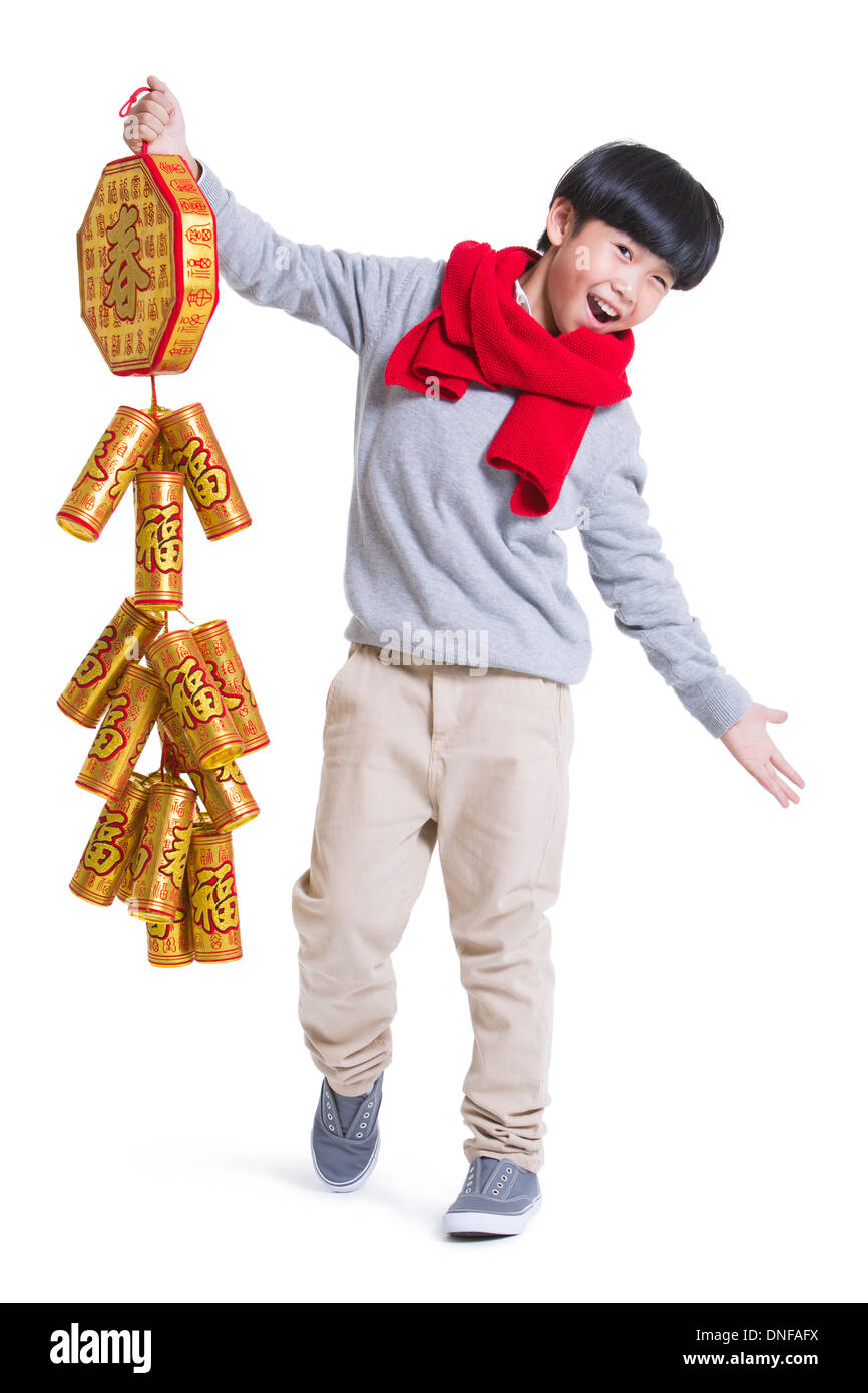 Happy boy with firecracker celebrating Chinese New Year Stock Photo - Alamy