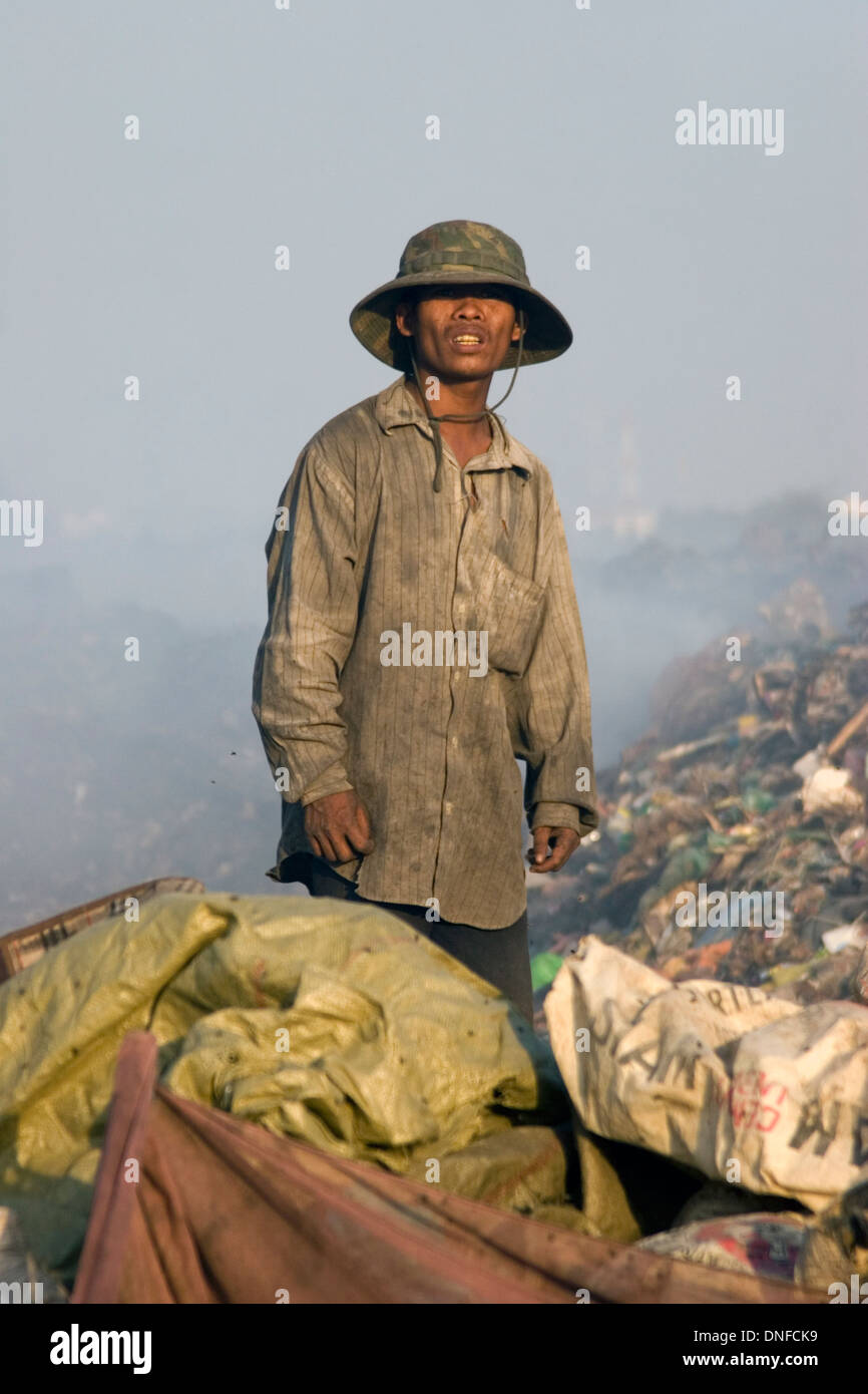 A scavenger man who collects recyclable material is working at at the ...