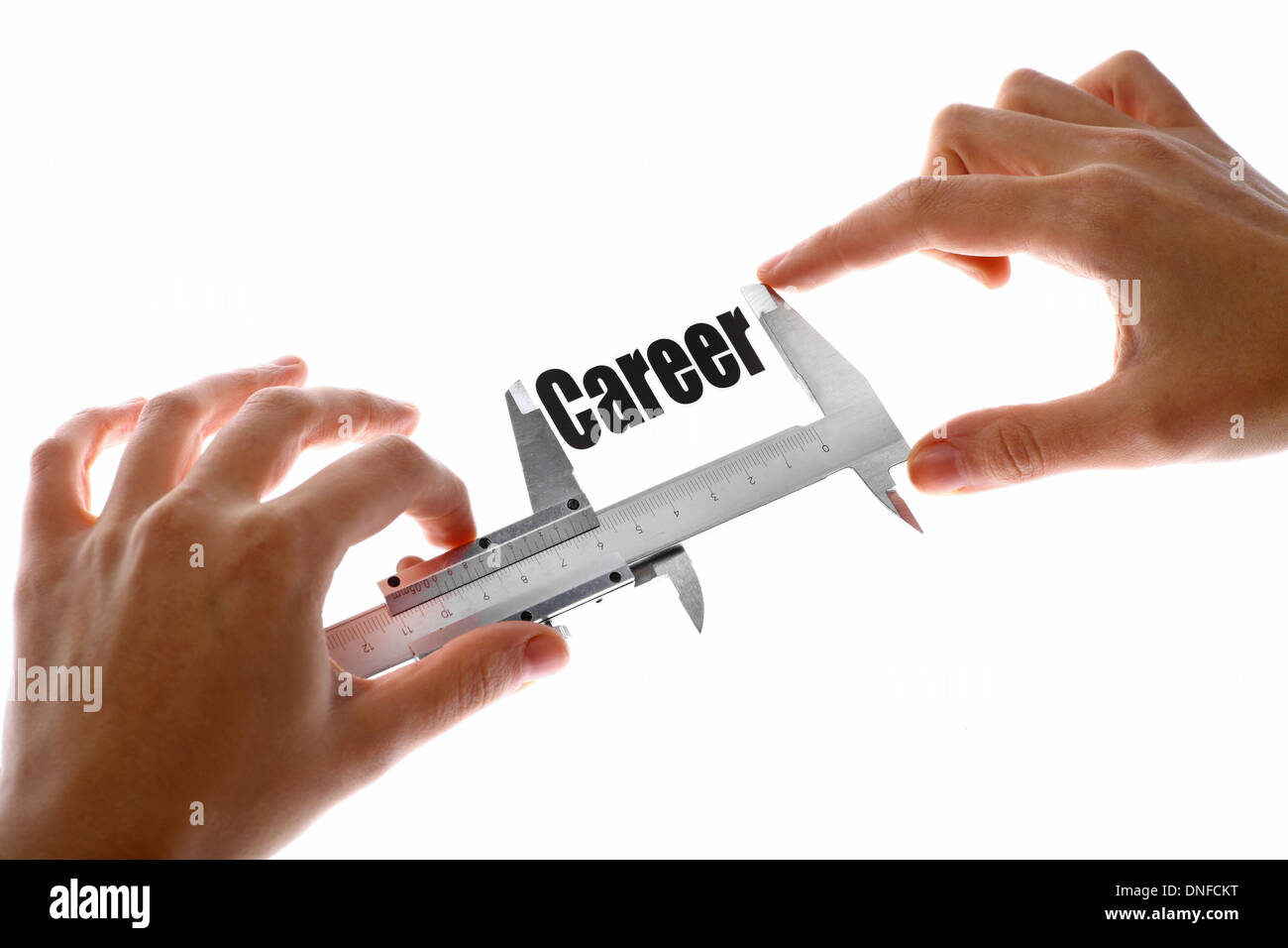 Two hands holding a caliper, measuring the word "Career Stock Photo - Alamy