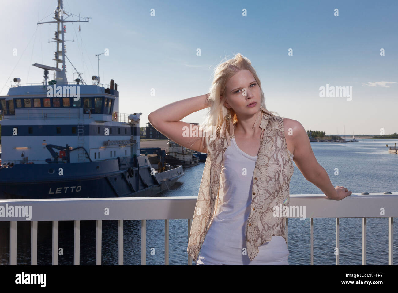 Beautiful woman leaning against railing hi-res stock photography and ...