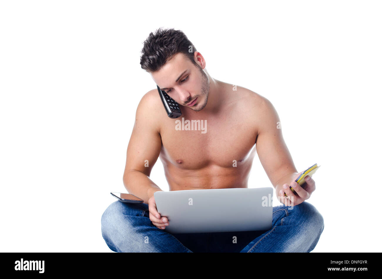 Shirtless muscular young man overwhelmed by technology, using laptop ...