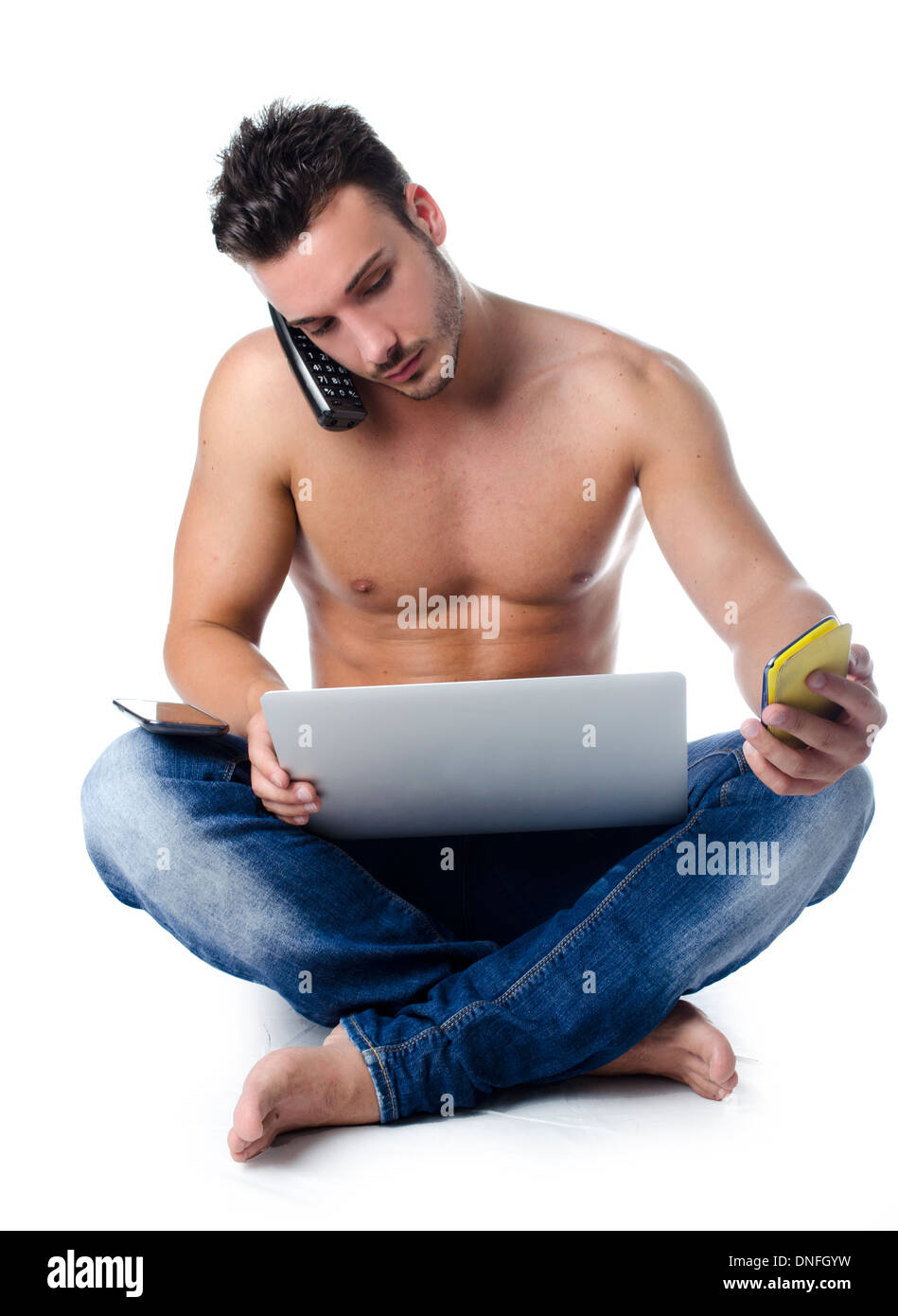 Shirtless muscular young man overwhelmed by technology, using laptop ...
