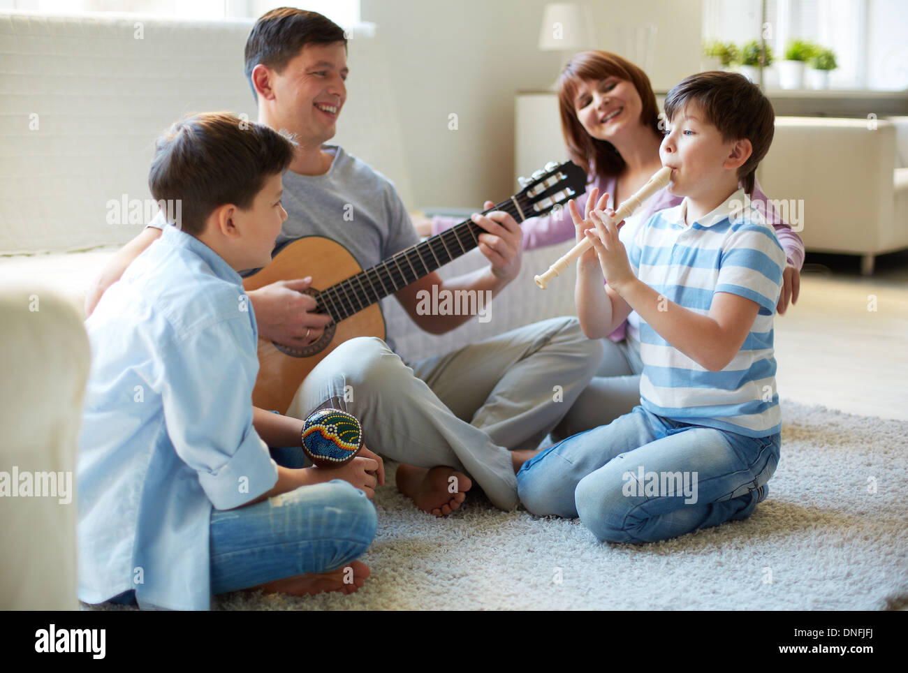 Portrait of handsome siblings and their father playing musical ...