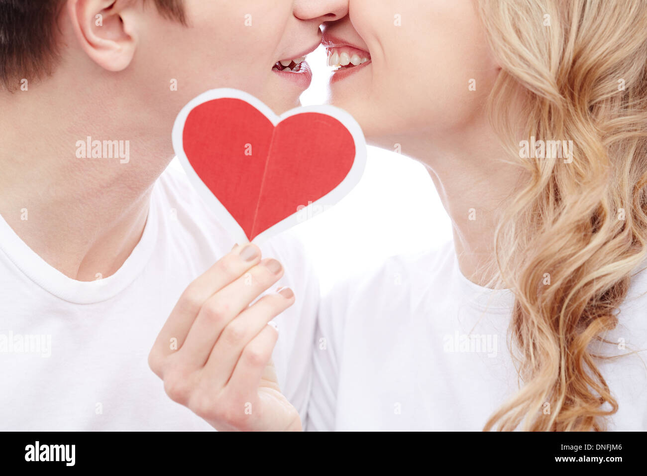 Close Up Of Young Amorous Couple Touching By Their Faces While Girl