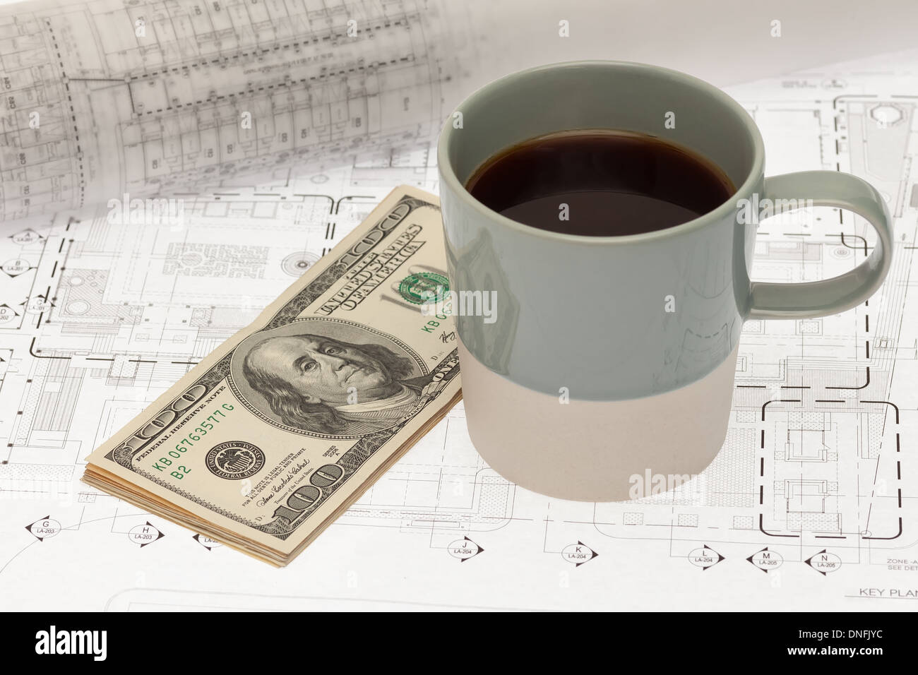 Coffee cup and money on architectural blueprint Stock Photo - Alamy