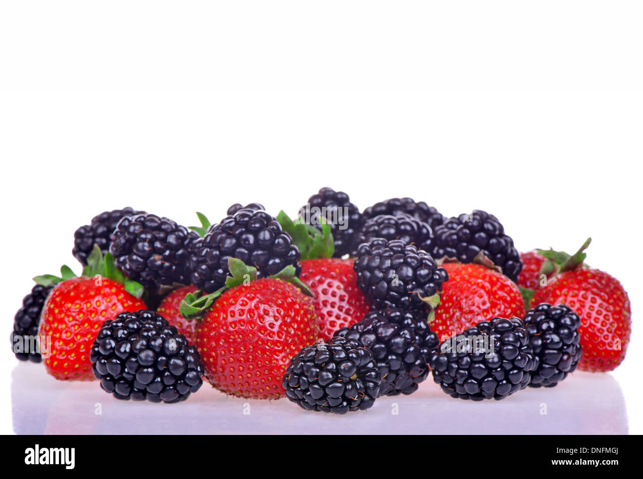 Strawberry and blackberry on the white background Stock Photo - Alamy