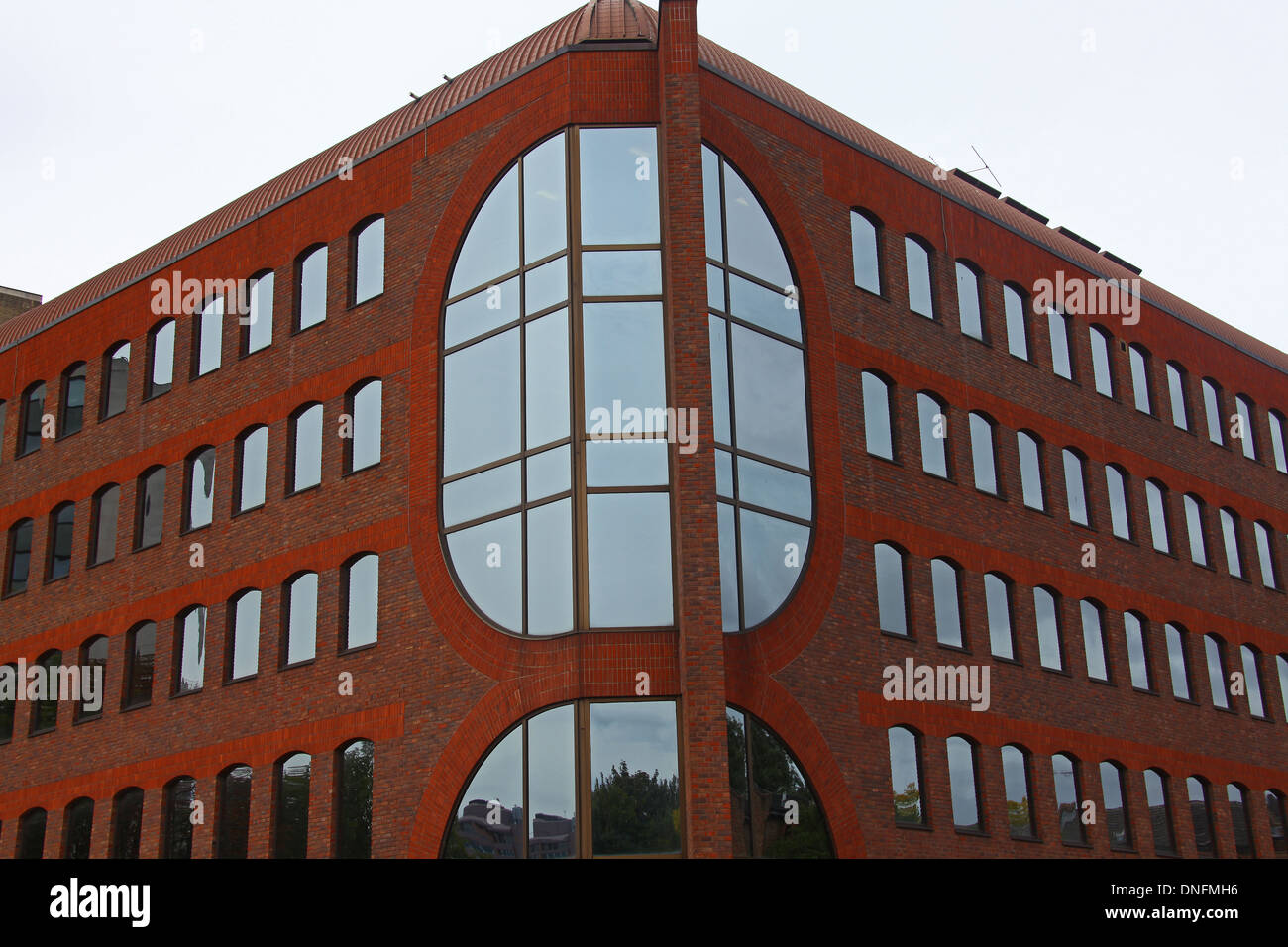 A view from a corner of a very large 4 storey brick built building with ...