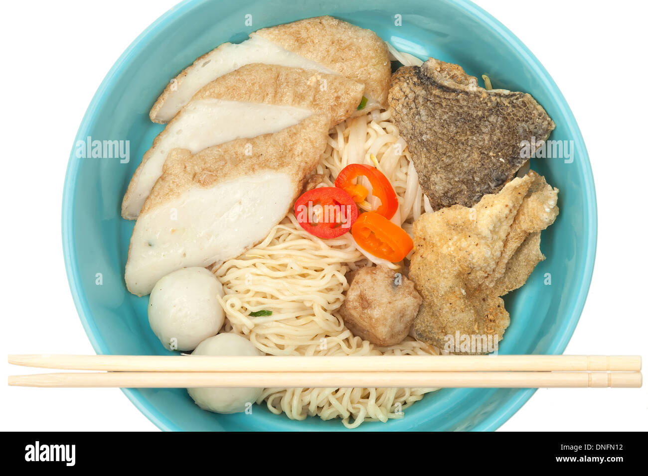 Delicious noodles with fish ball in bowl isolated on white background ...