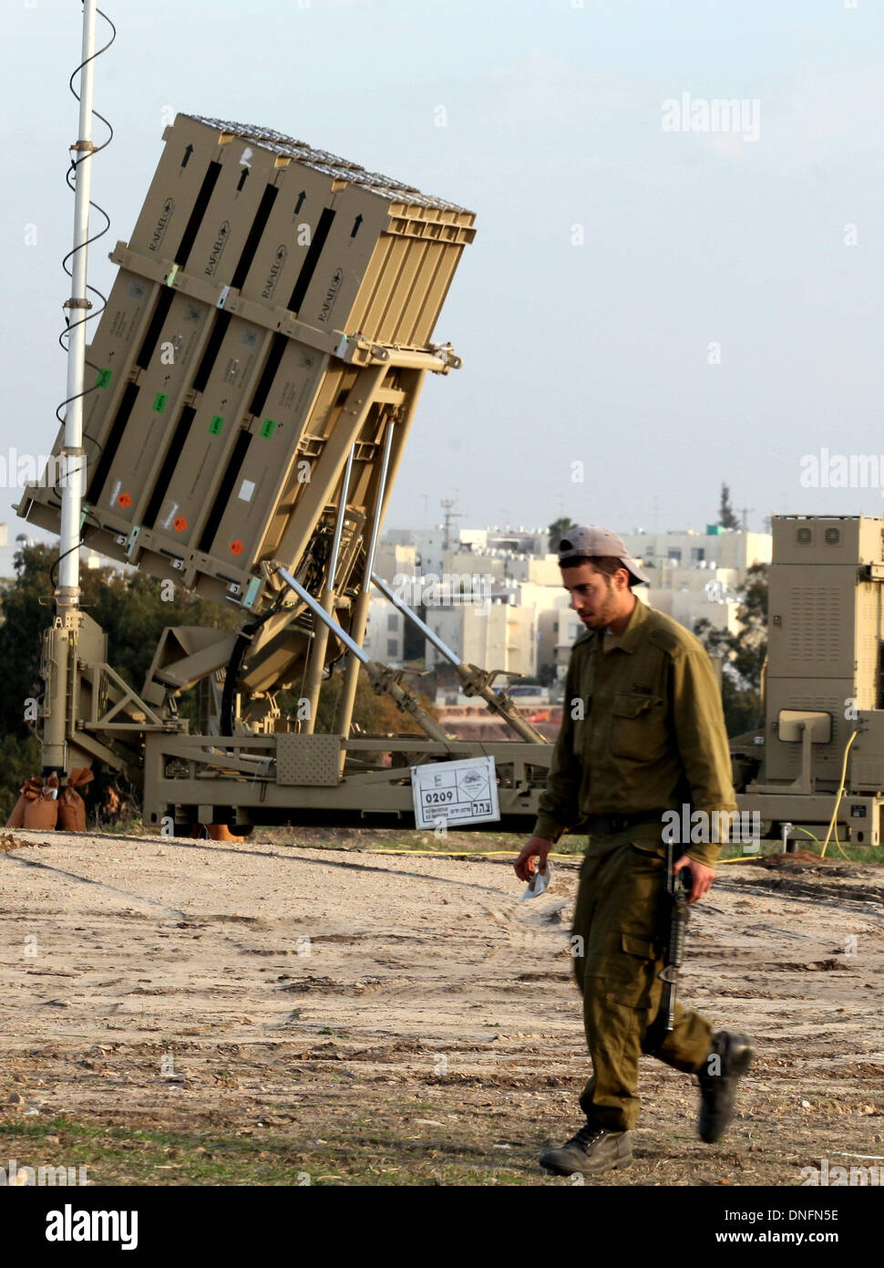 Jerusalem. 26th Dec, 2013. An Israeli soldier walks past an Iron Dome ...