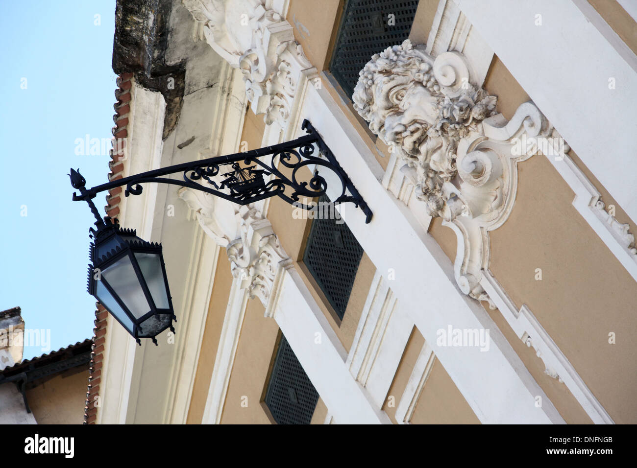Lantern and gargoyle on wall, Lisbon Stock Photo - Alamy